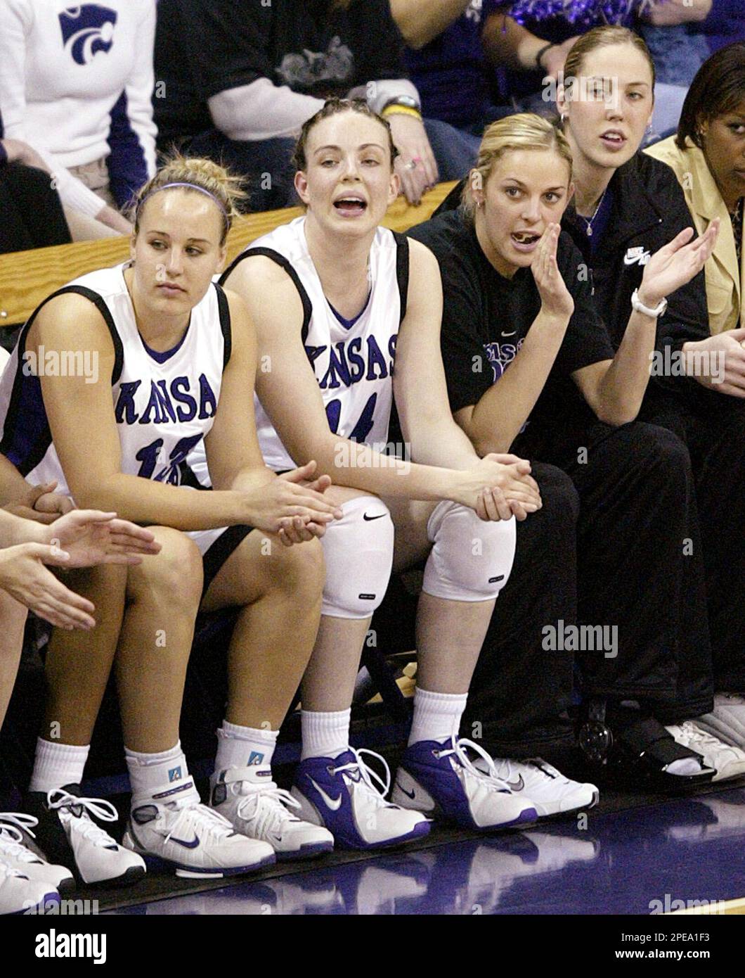 Injured Kansas State guard Megan Mahoney, clapping at right, cheers ...