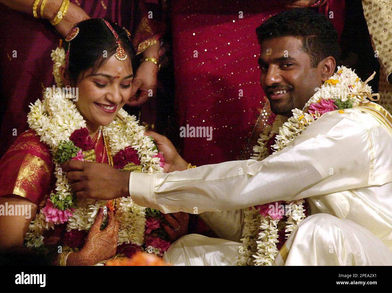Sri Lankan cricketer Muttaiah Muralitharan, right, garlands Madhimalar ...