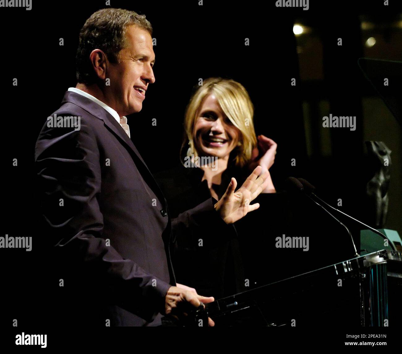 Fashion photographer Mario Testino, left, addresses the crowd after ...