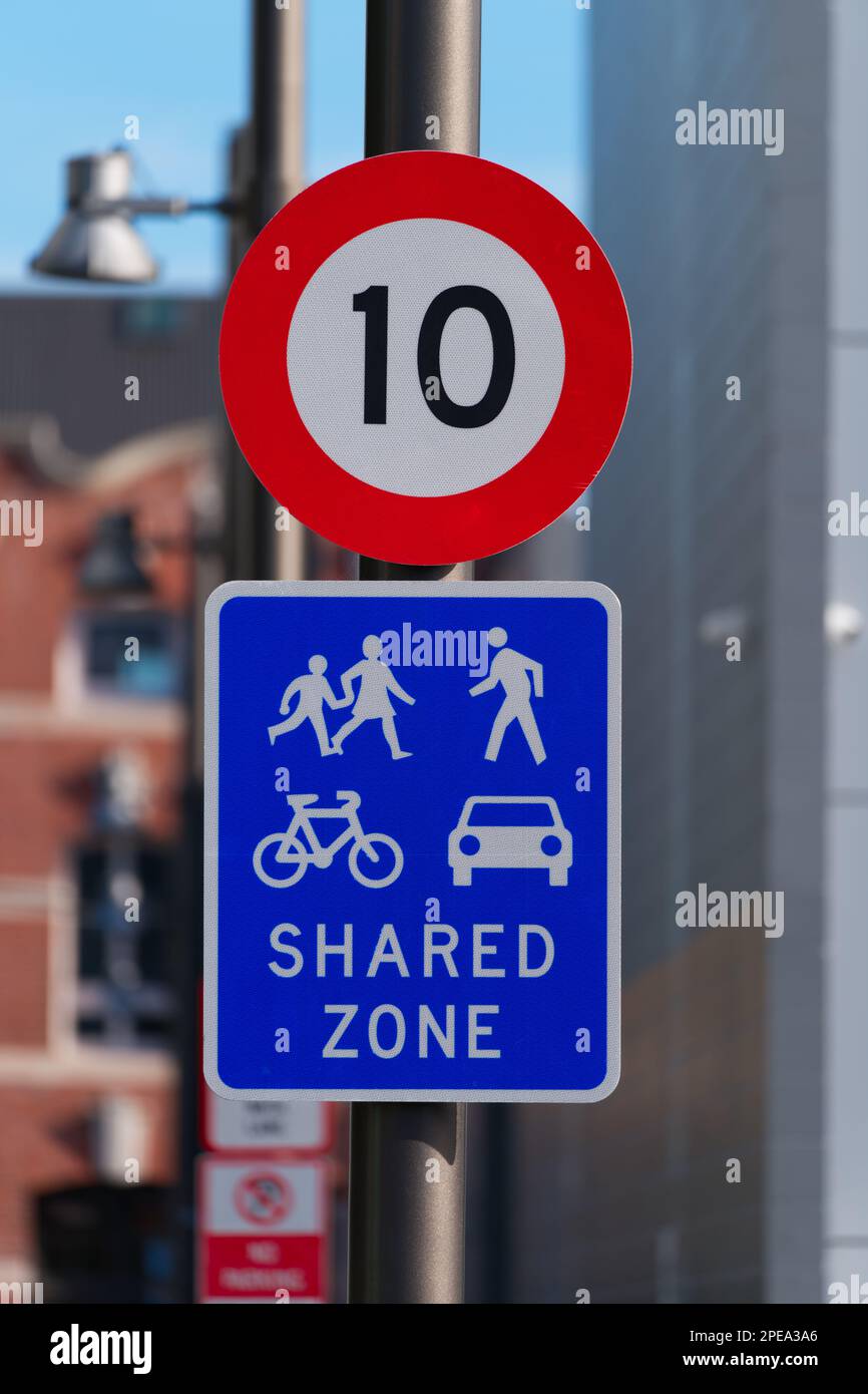 Street sign on road showing pedestrian zone and 10 km speed limit ...