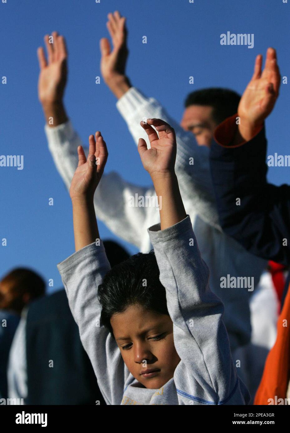 People take in the first rays of sun during spring equinox on top of ...