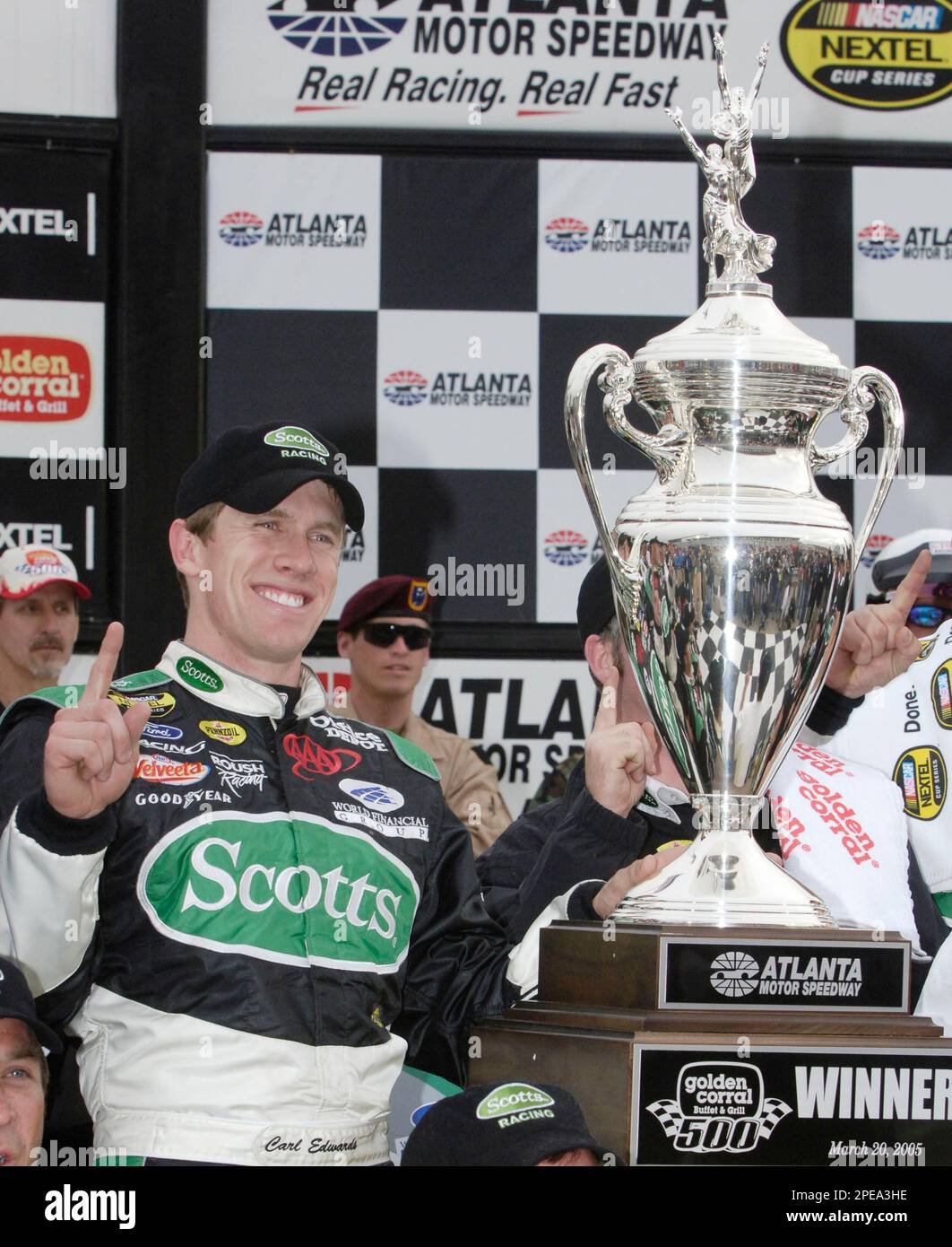 Carl Edwards reacts with the trophy in Victory Lane after winning the ...