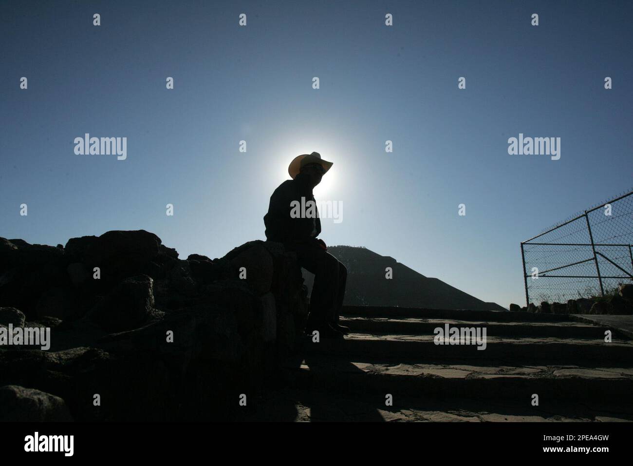 A man sits at the entrance to the Pyramid of the Sun during spring ...