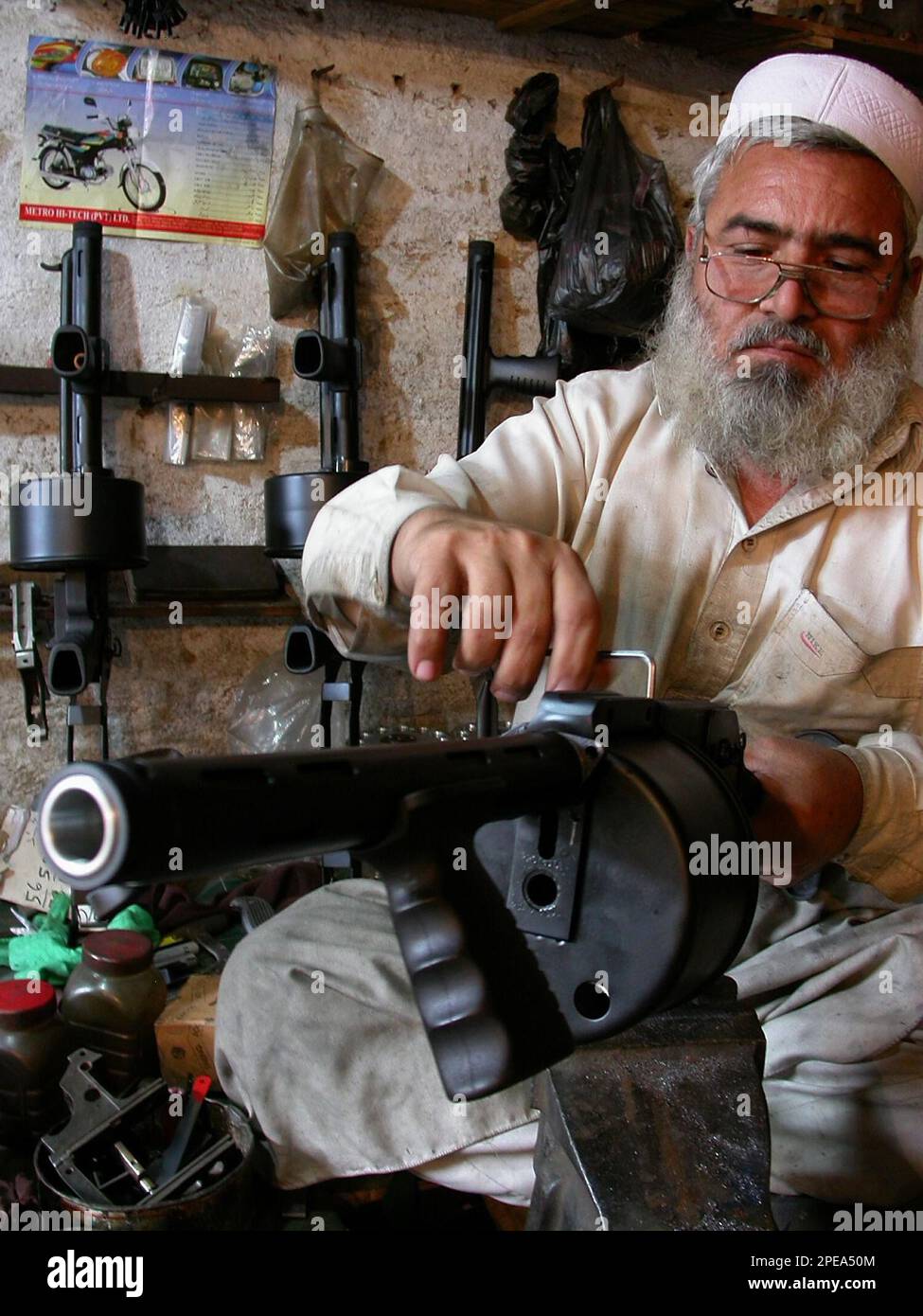 Pakistani tribal gunmaker Abdullah gives final touches to a local-made ...