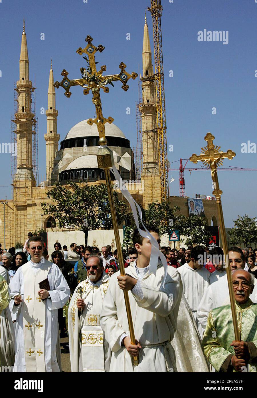 Lebanese Christian clergymen carry crosses during the traditional Palm ...