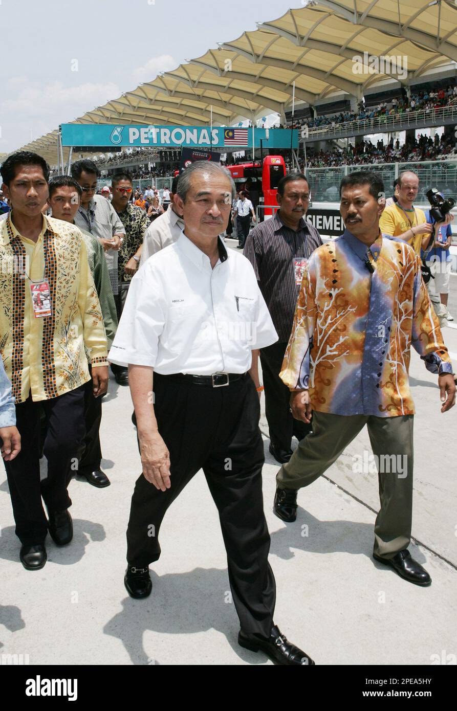 Malaysia's Prime Minister Abdullah Ahmad Badawi walks at the pit lane ...