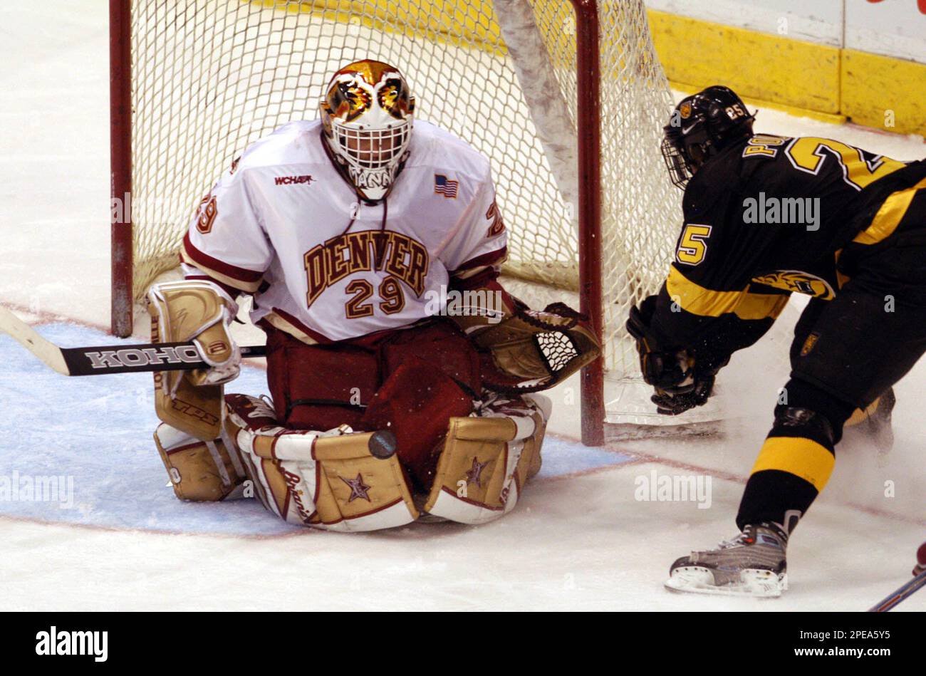 Denver goalie Peter Mannino (29) blocks a shot by Colorado College's ...