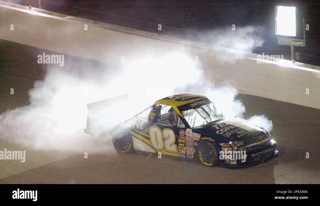 Kelly Sutton leaves a trail of smoke from his truck under the lights ...