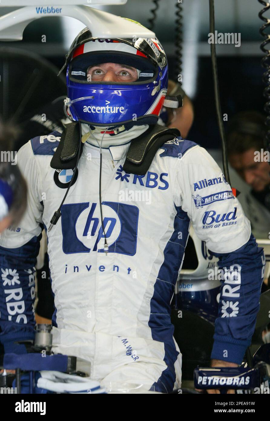 Williams-BMW F1 driver Mark Webber of Australia gets into his car ...
