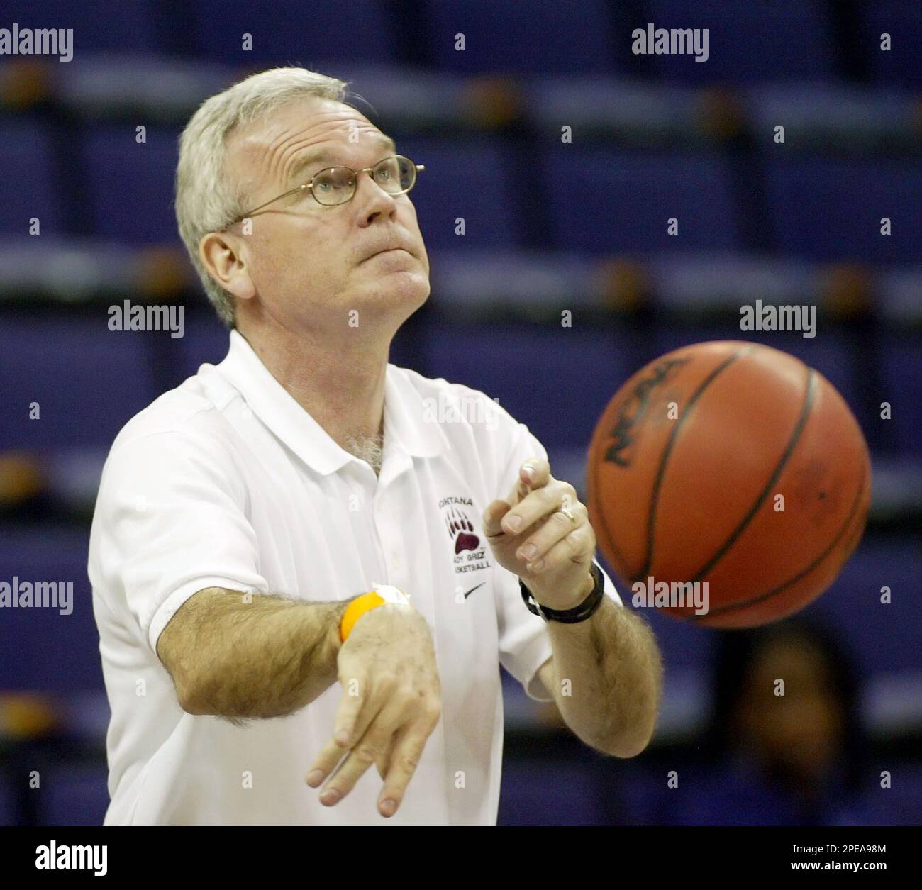 Montana head coach Robin Selvig tosses the ball back out from under the ...