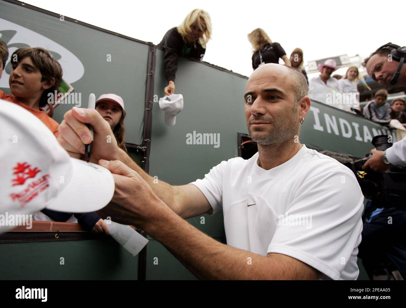 Andre Agassi signs autographs to fans after he announced his was ...