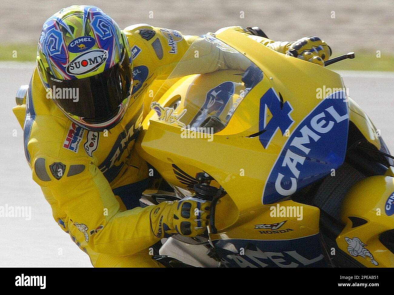 Brazilian Moto GP rider Alex Barros, takes a curve with his Camel Honda ...