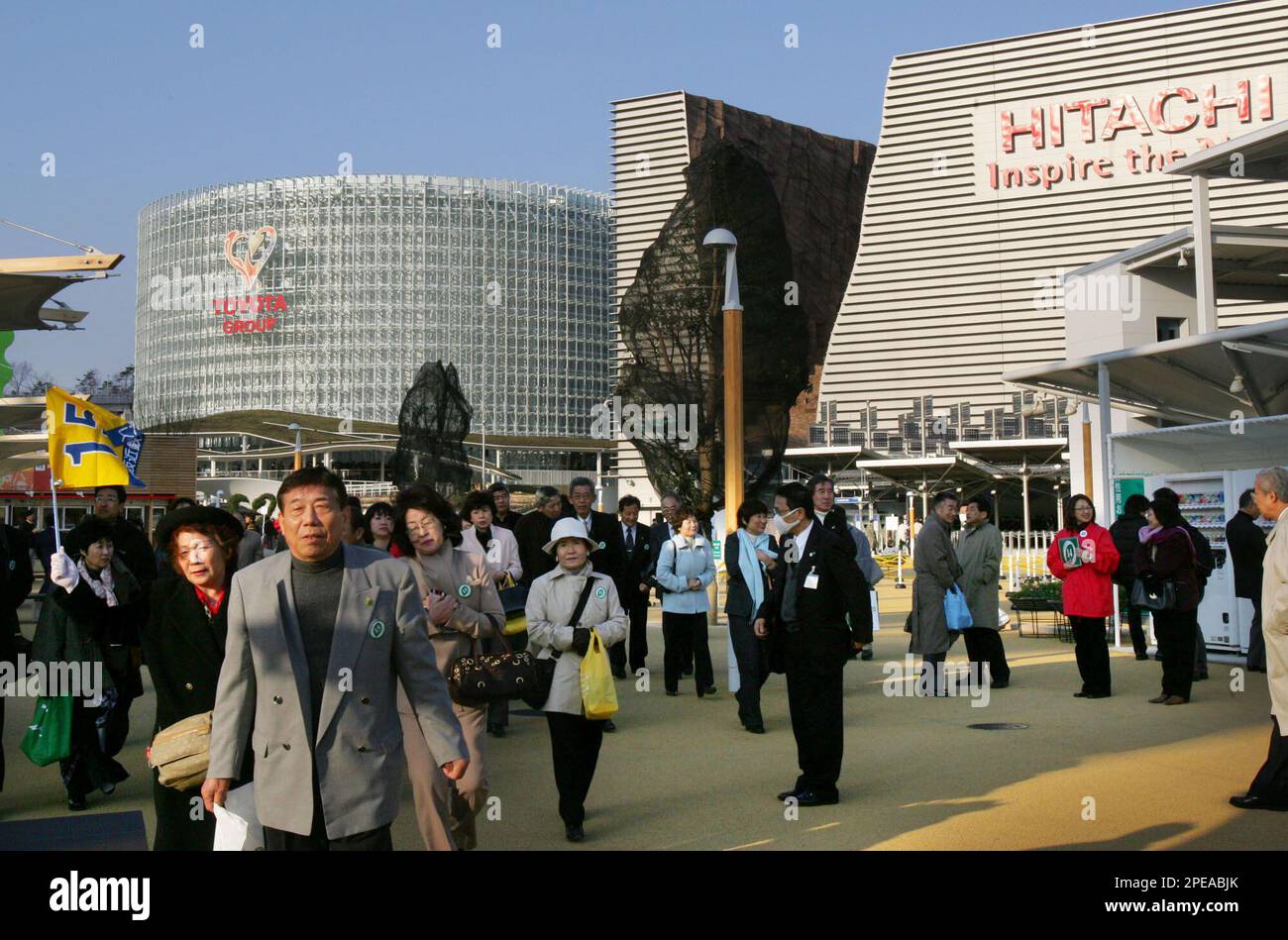 Visitors walk by corporate pavilions during a press preview of the ...