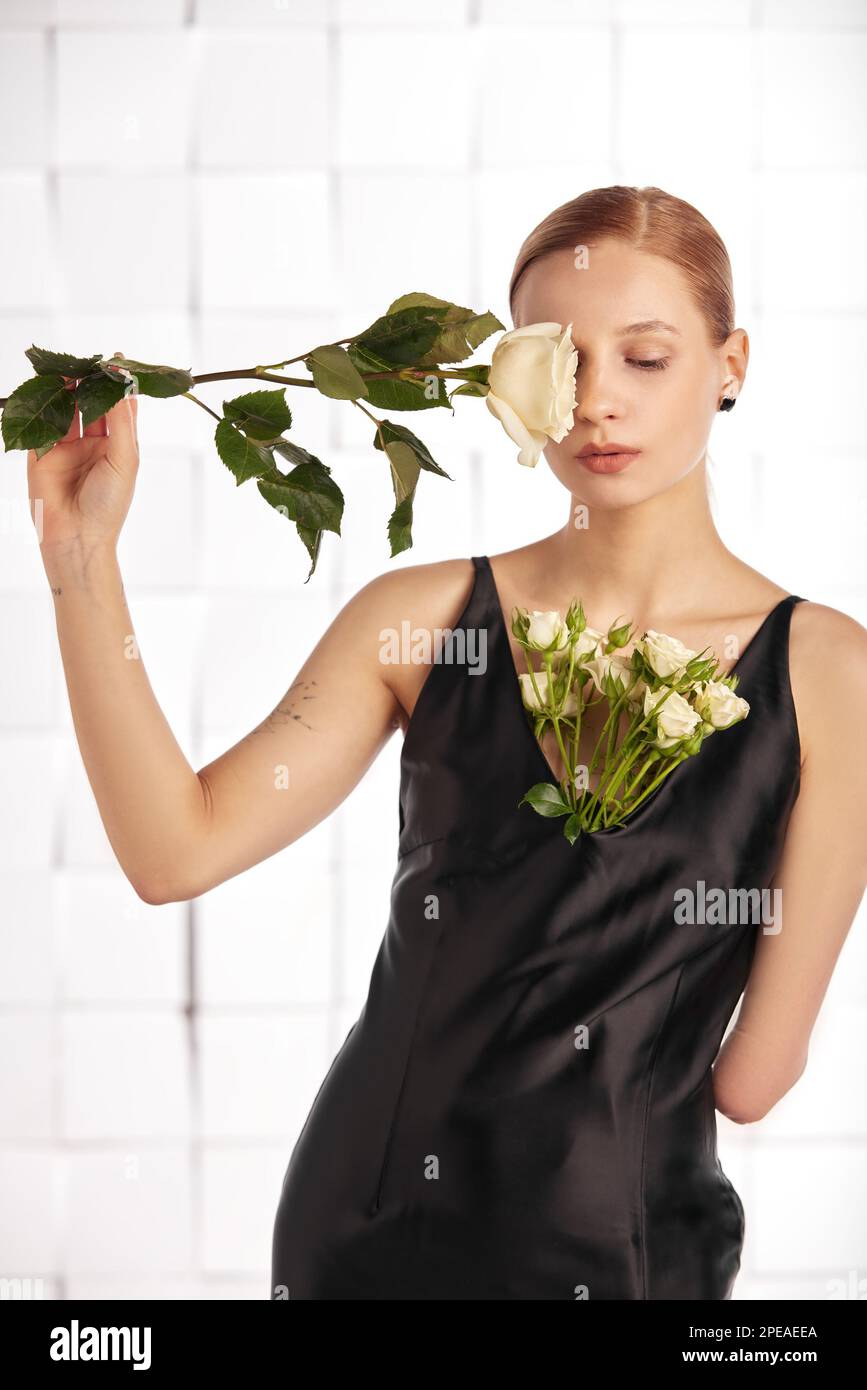 Beautiful young with special needs woman with flowers in her hand ...