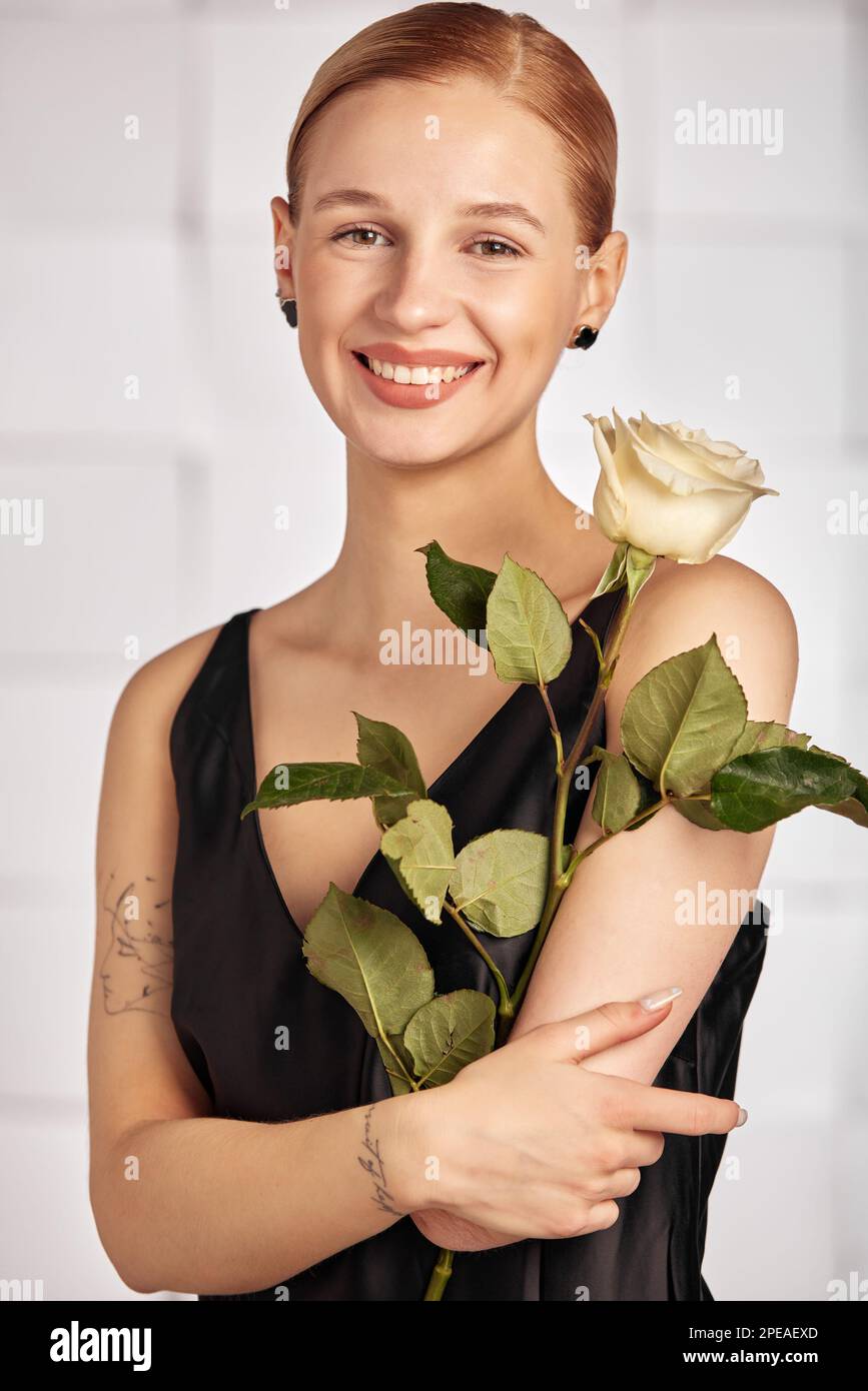 Beautiful young with special needs woman with flowers in her hand ...