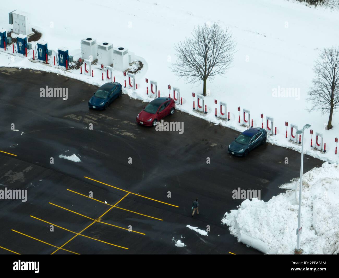A high aerial photo looking at three parked Tesla electric vehicles at ...