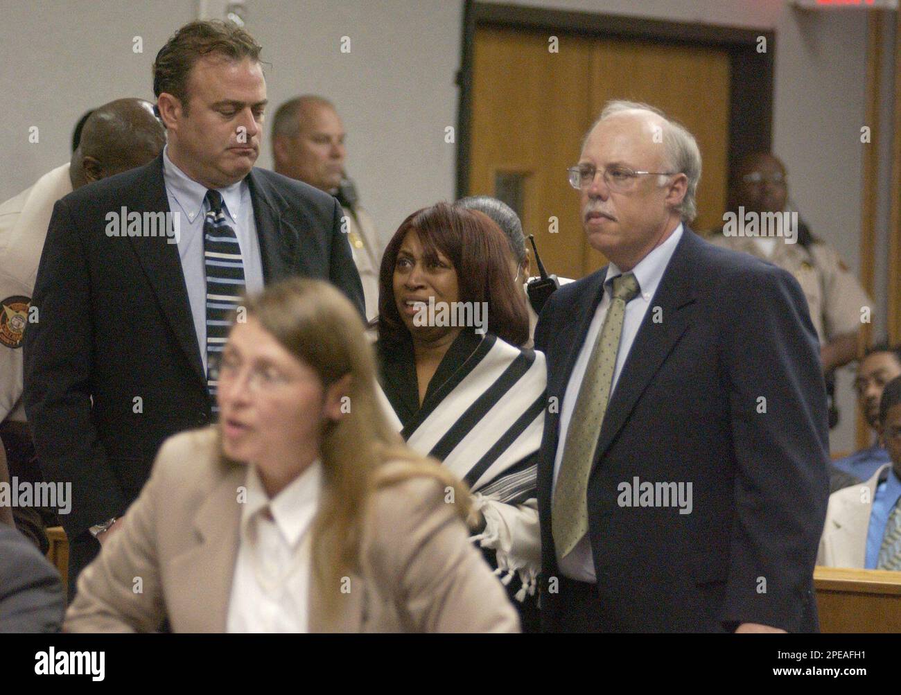 Sharron Nicole Redmond, center, is flanked by her attorneys Brian Daly ...
