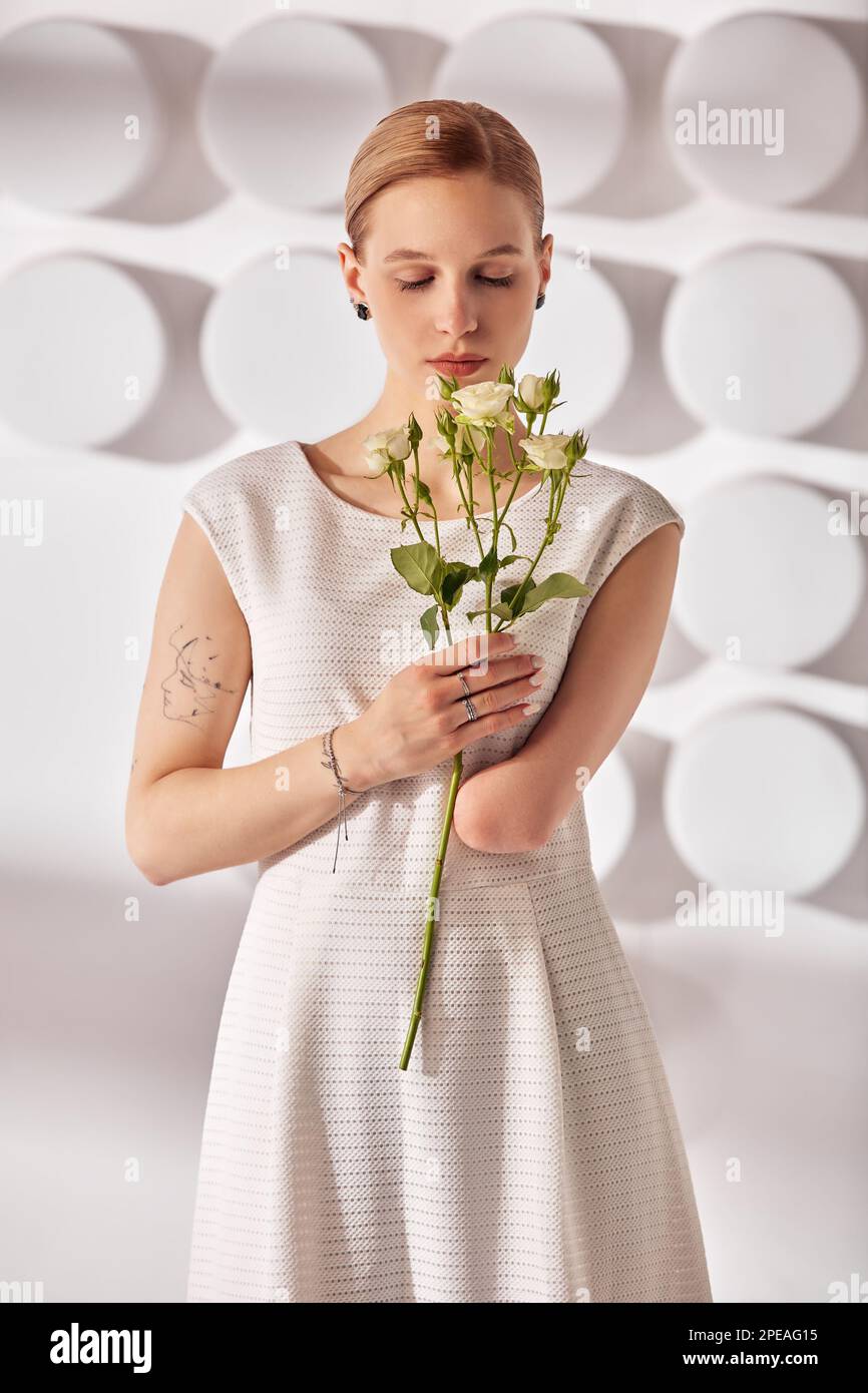 A young woman with special needs with flowers in her hand, a girl born ...