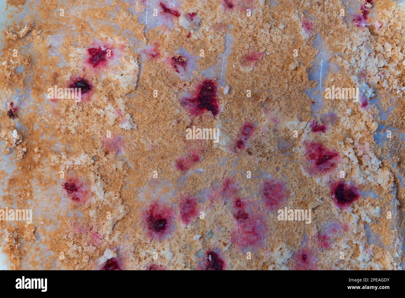 Abstract background. Cake crumbles and cherry prints left after cake on ...