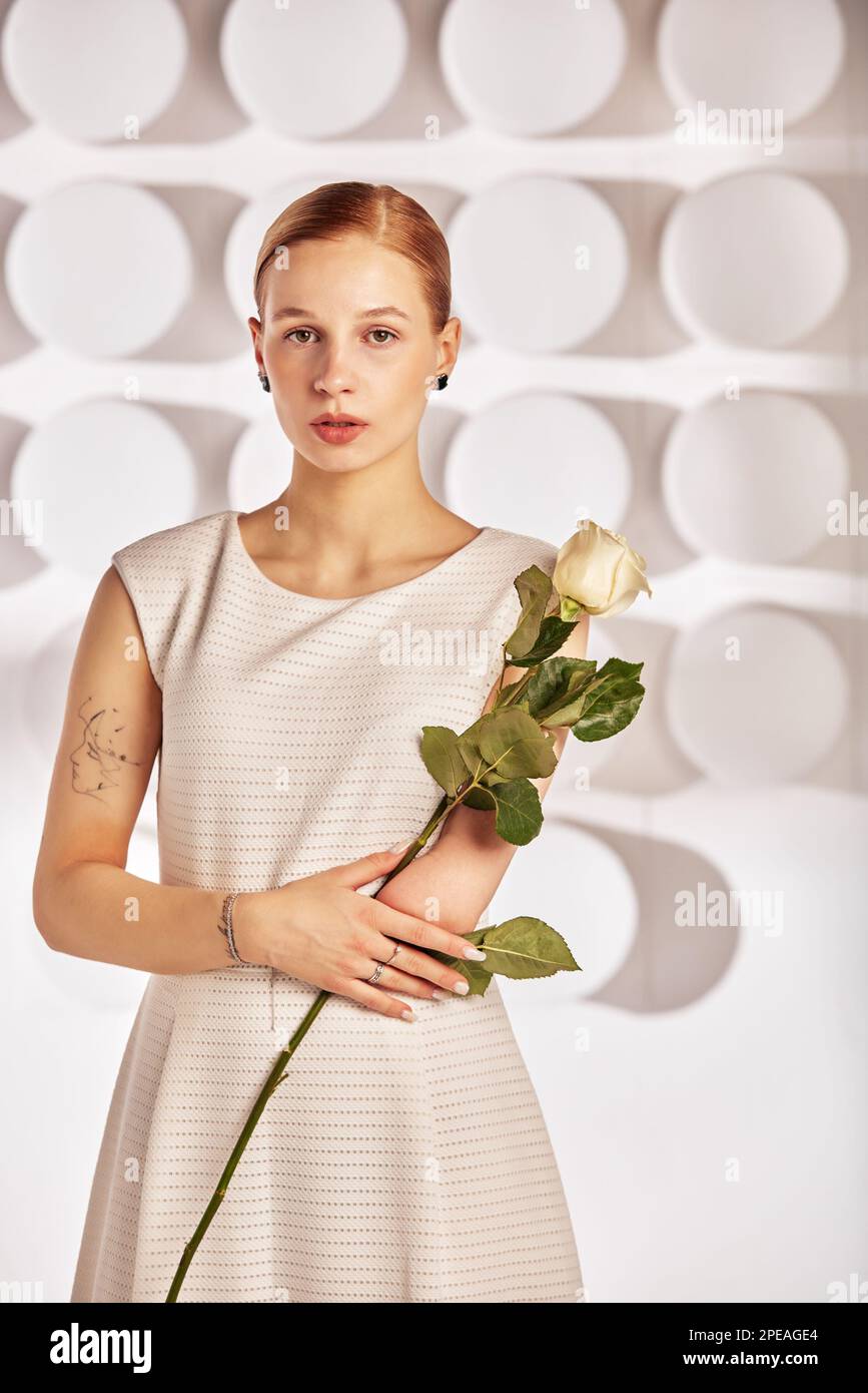 A young woman with special needs with flowers in her hand, a girl born ...
