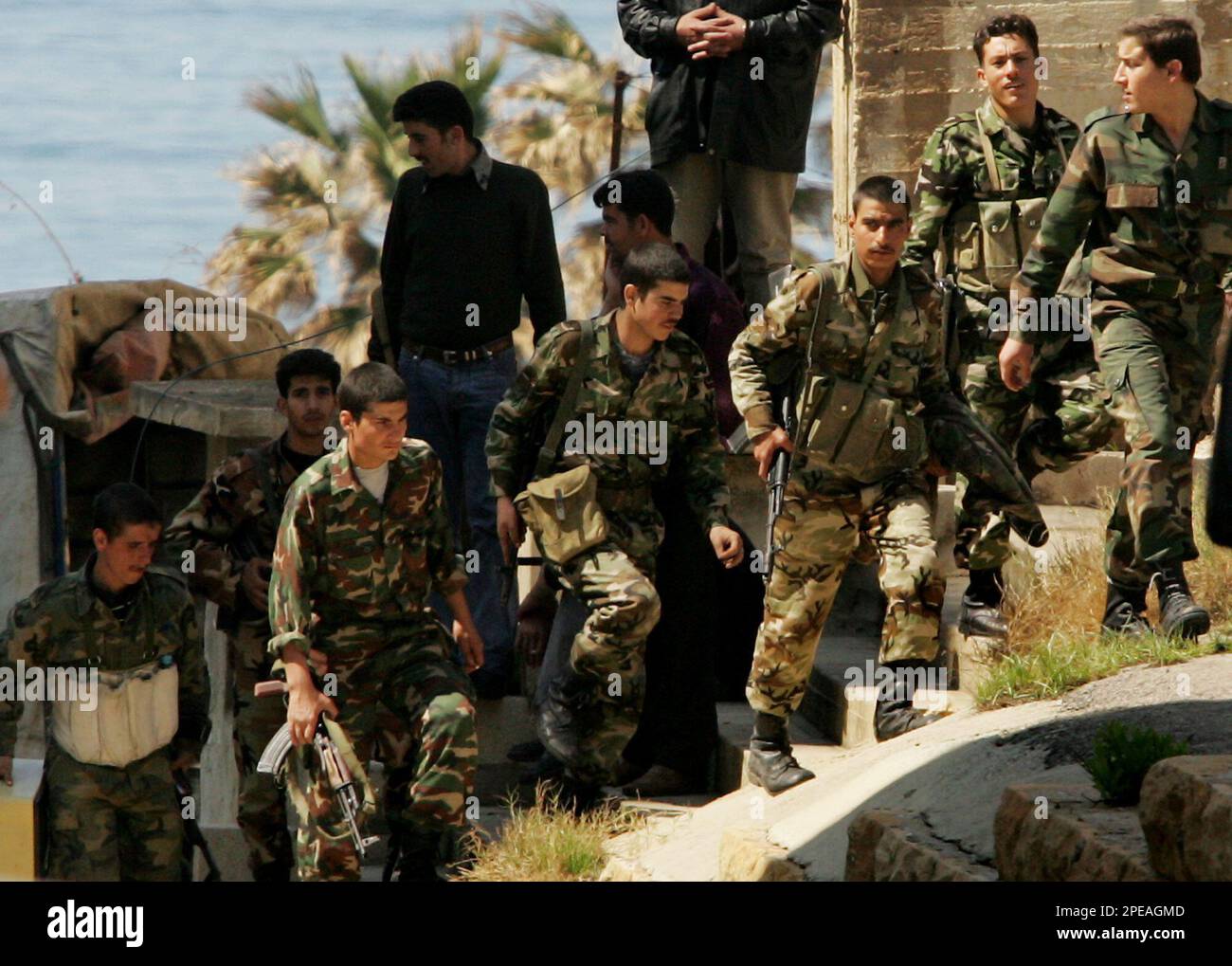 Syrian military intelligence soldiers evacuate the building used as the ...