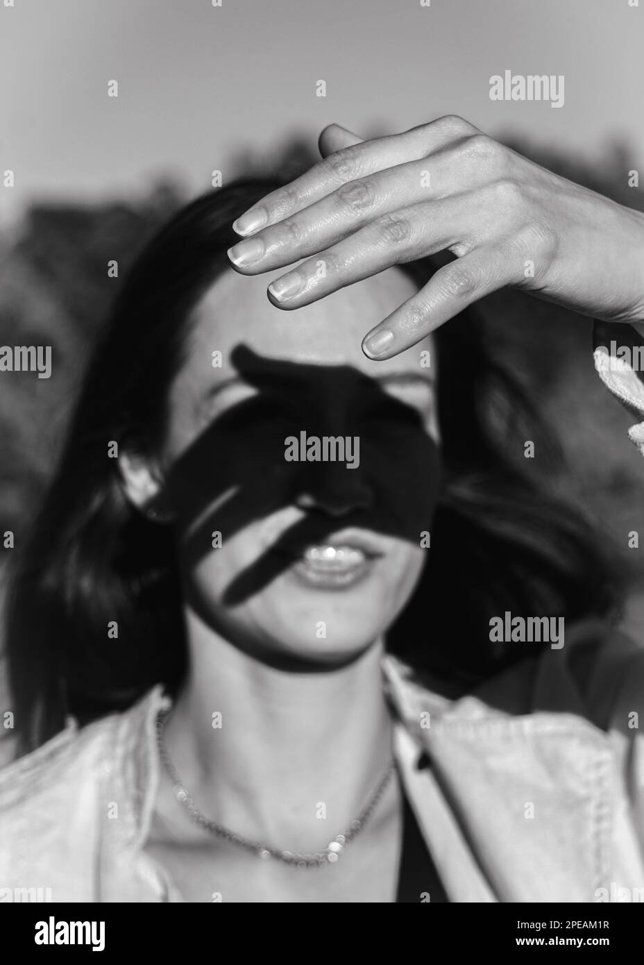 Shielding her face and eyes with hand hi-res stock photography and ...