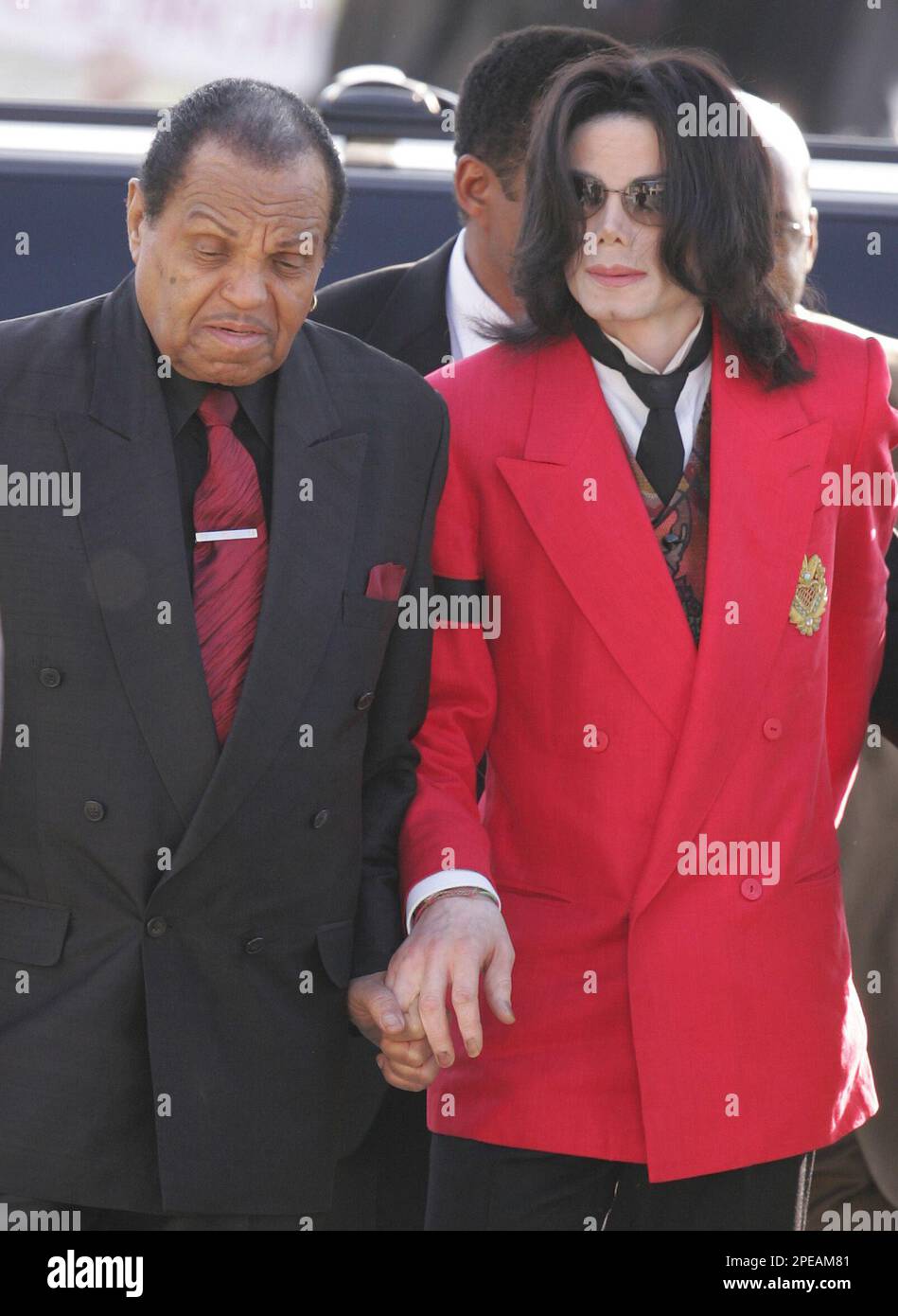 Pop star Michael Jackson and his father Joe Jackson, left, hold hands ...