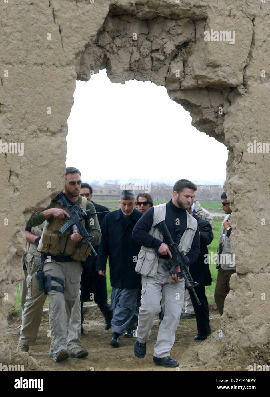 Afghan President Hamid Karzai, center, is surrounded by heavily armed ...