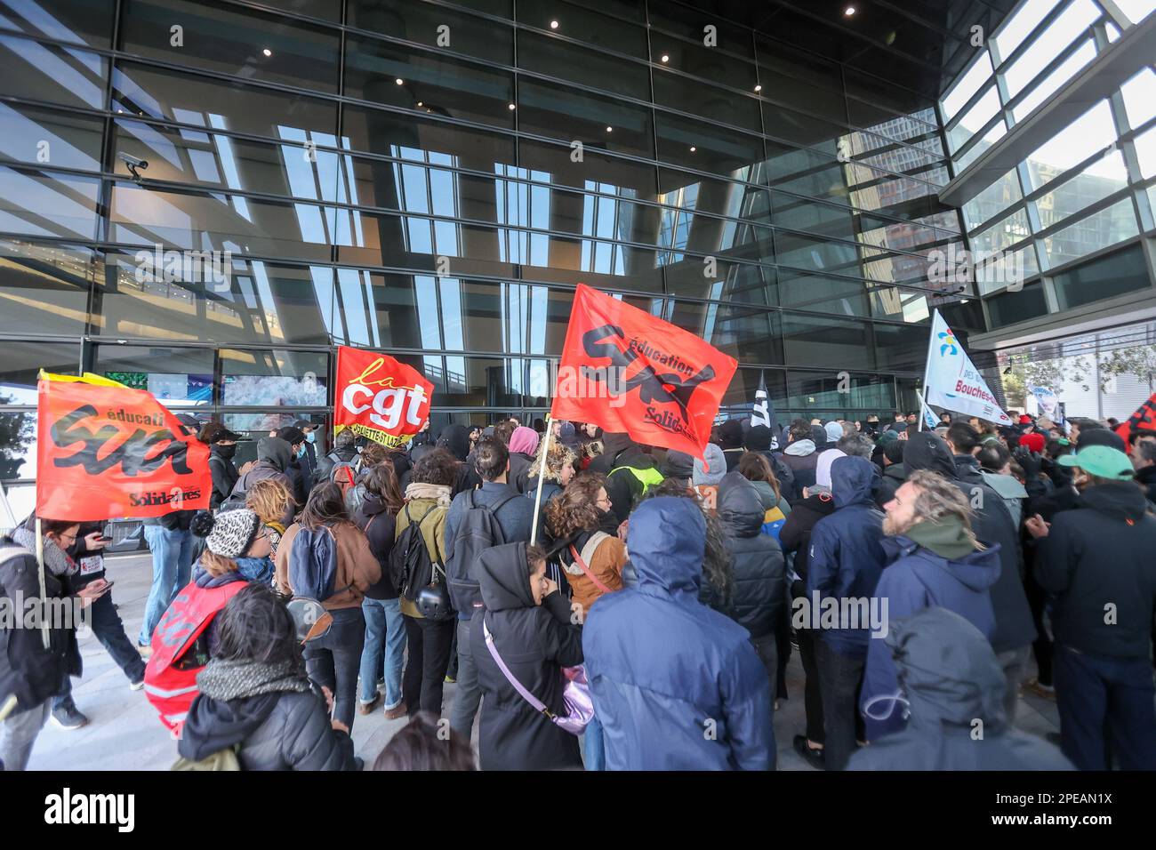 Marseille, France. 15th Mar, 2023. Protesters hold flags as they block ...