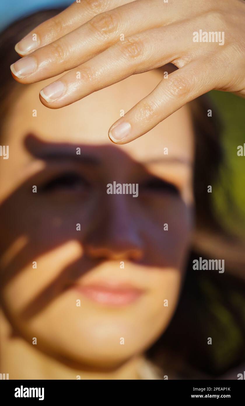 Shielding her face and eyes with hand hi-res stock photography and ...