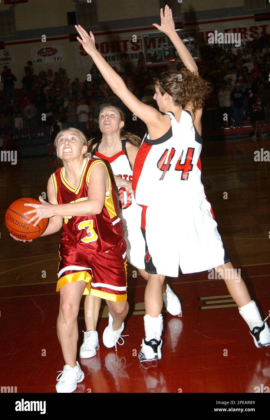 Sioux Falls Roosevelt's Megan Stadler, left, moves to the basket around ...