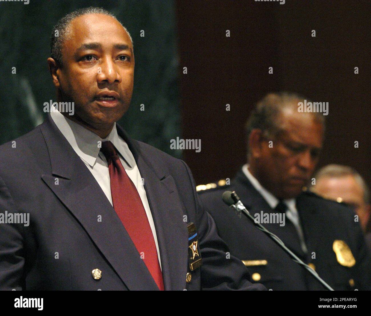 Fulton County Sheriff Myron Freeman speaks to news media, flanked by ...