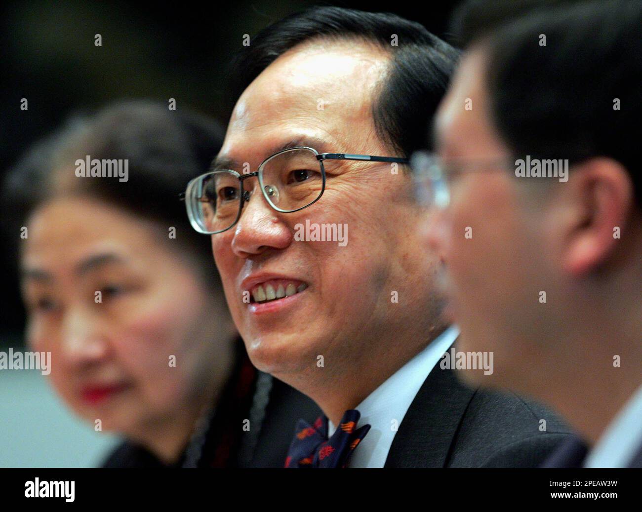 Hong Kong's acting Chief Executive, Donald Tsang, center, smiles during ...
