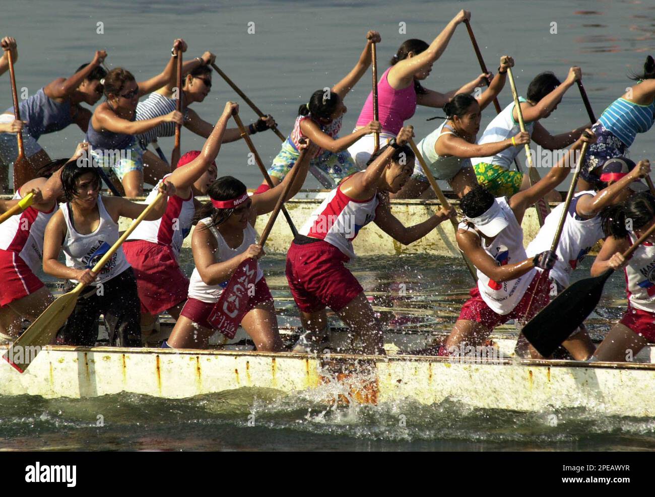 Two competing female rowing team try to beat each other to the finish ...