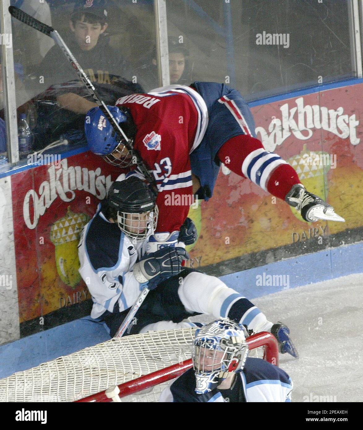 Massachusetts-Lowell forward Bobby Robins (23) checks Maine's Tom ...