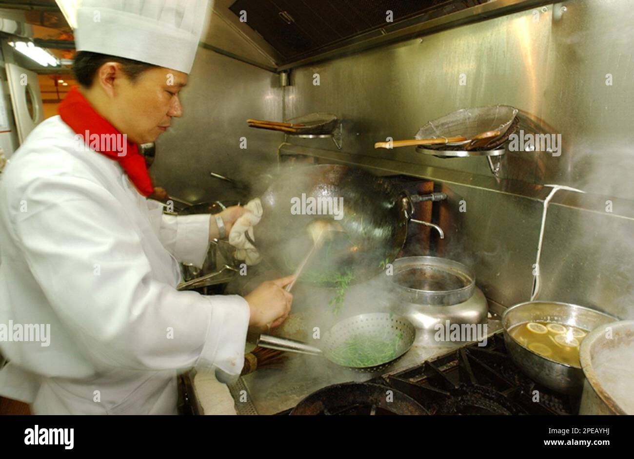 ** FOR USE WITH AP WEEKLY FEATURES ** Chef Peng Gaofa cooks fried ...