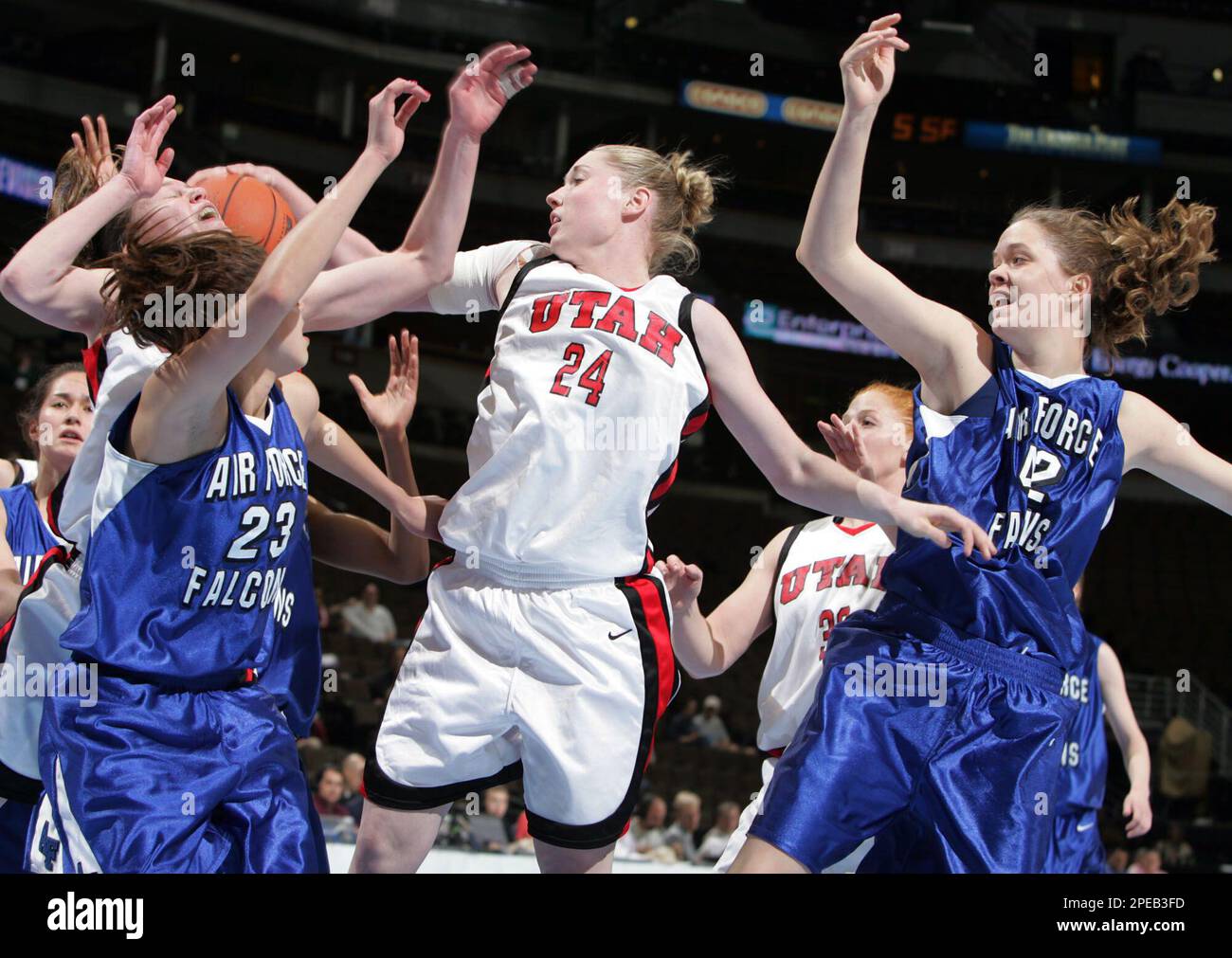 Utah center Camie Allen, center, swats at a rebound as teammate Kim ...