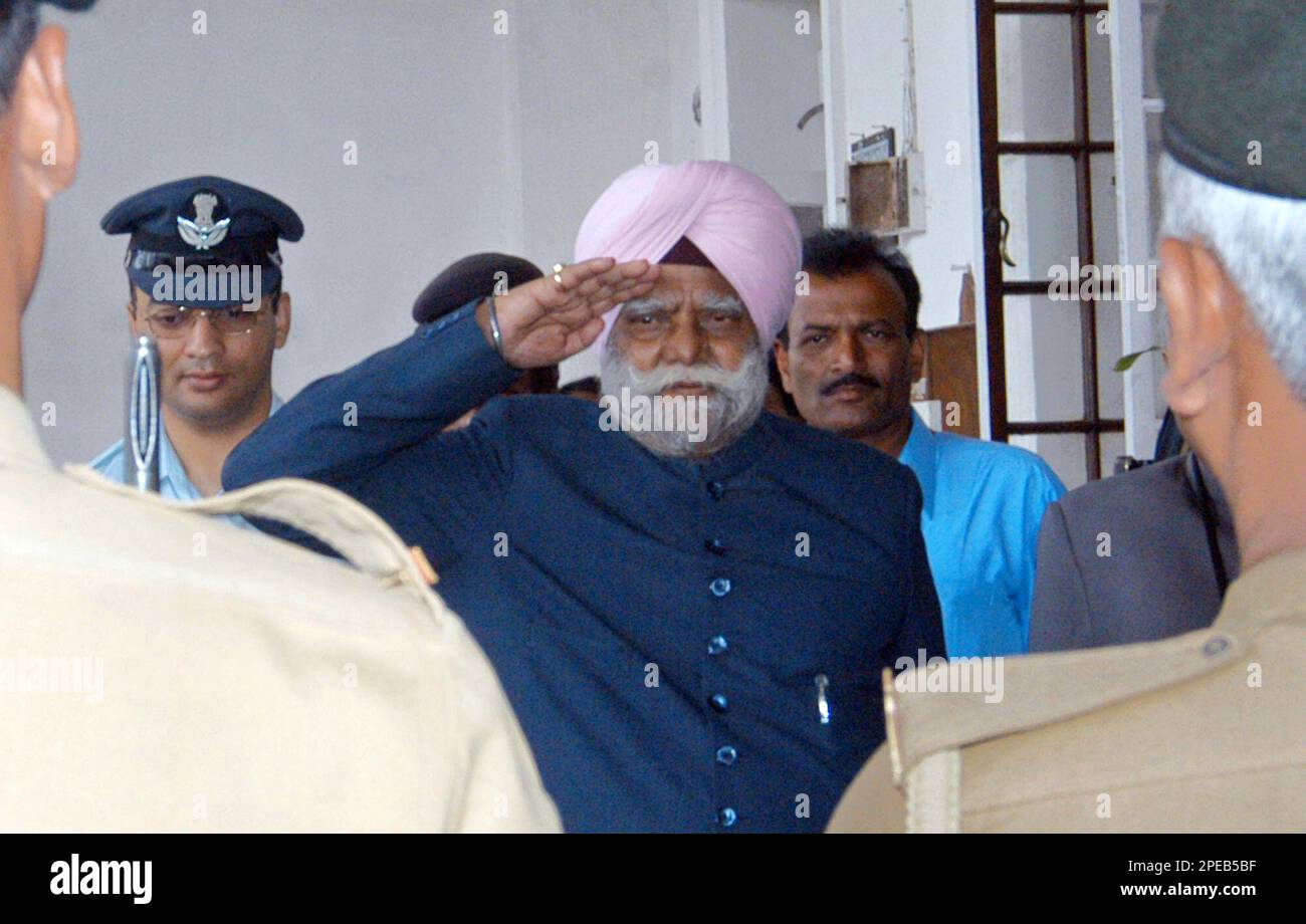 Governor of Indian state of Bihar, Buta Singh, center, salutes at his ...