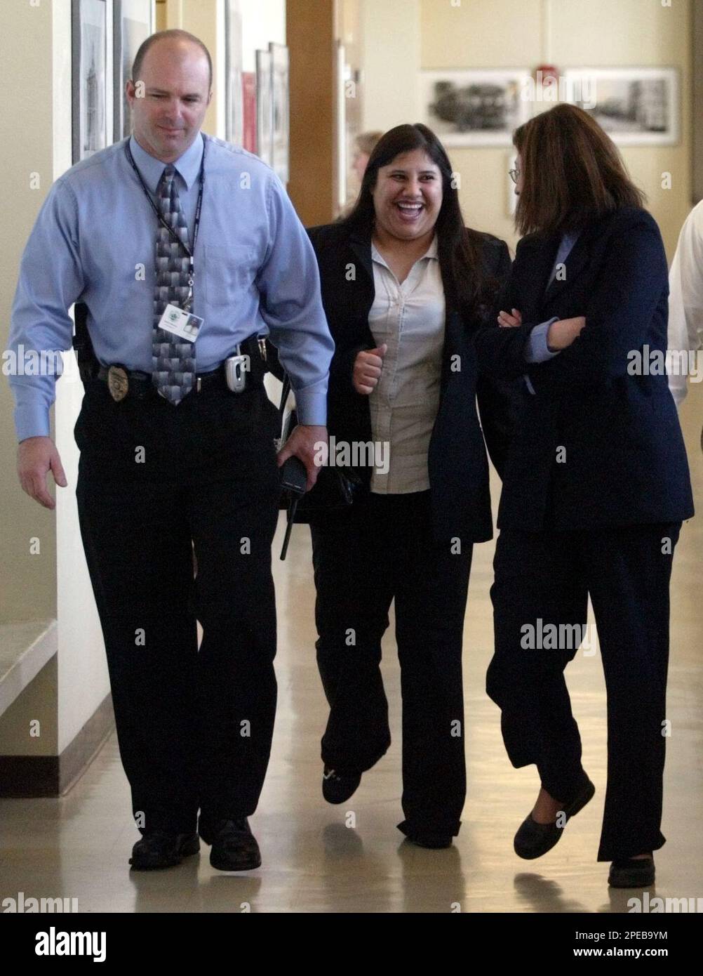 Sofina Solorio, center, led by district attorney investigators and the ...