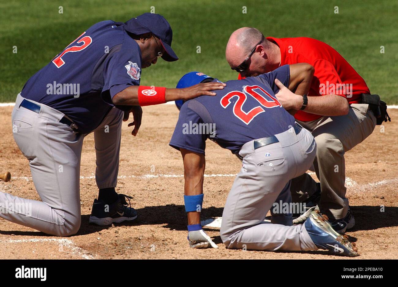 Chicago Cubs manager Dusty Baker (12) and trainer Ed Halbur, right ...
