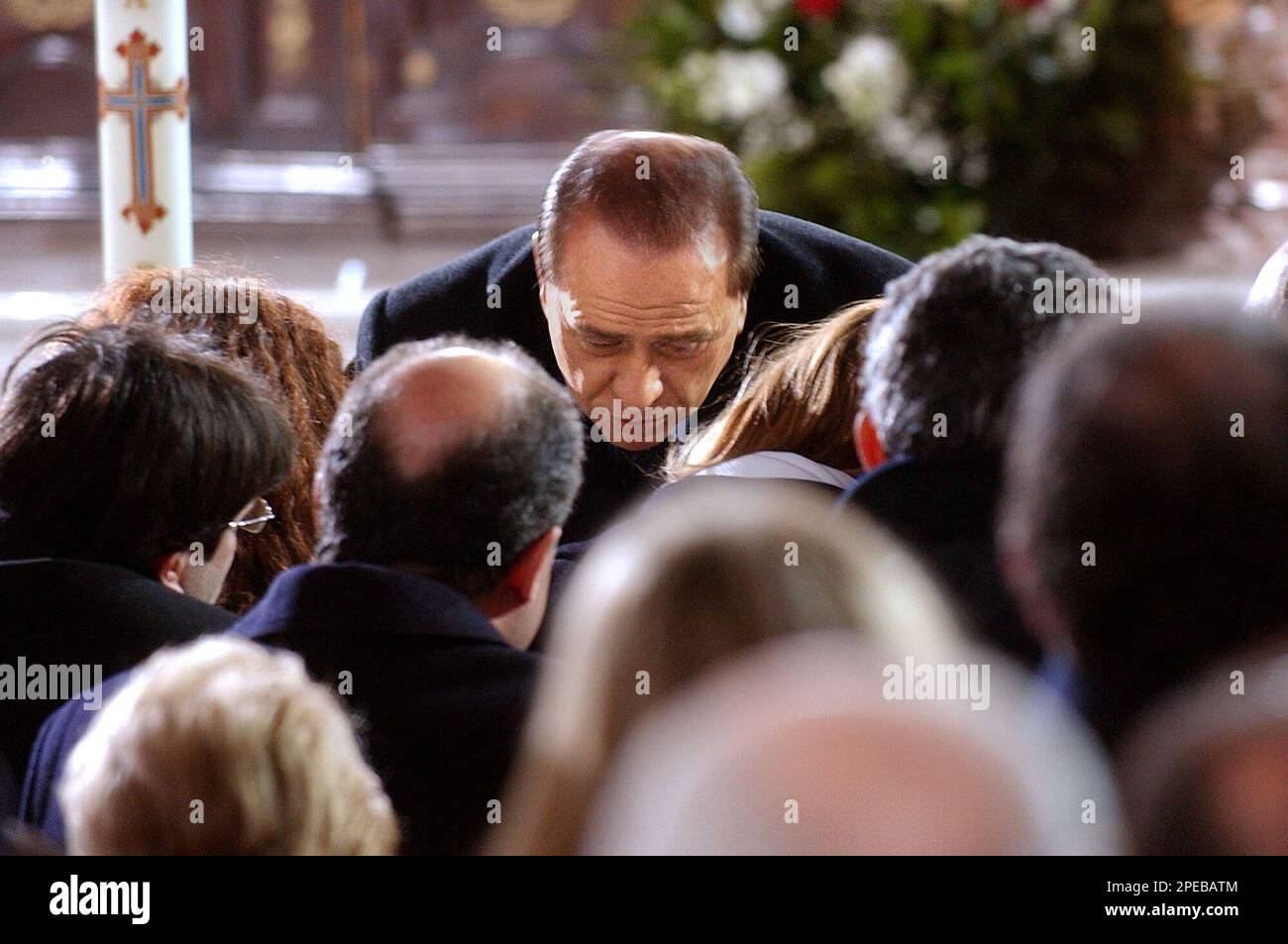 Italian Premier Silvio Berlusconi, center, speaks to the relatives of ...