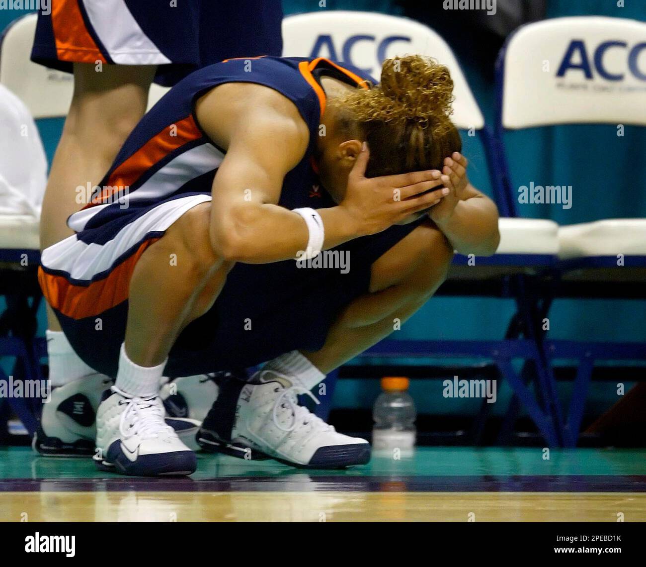 Virginia's Sharnee Zoll hangs her head on the bench during the final ...