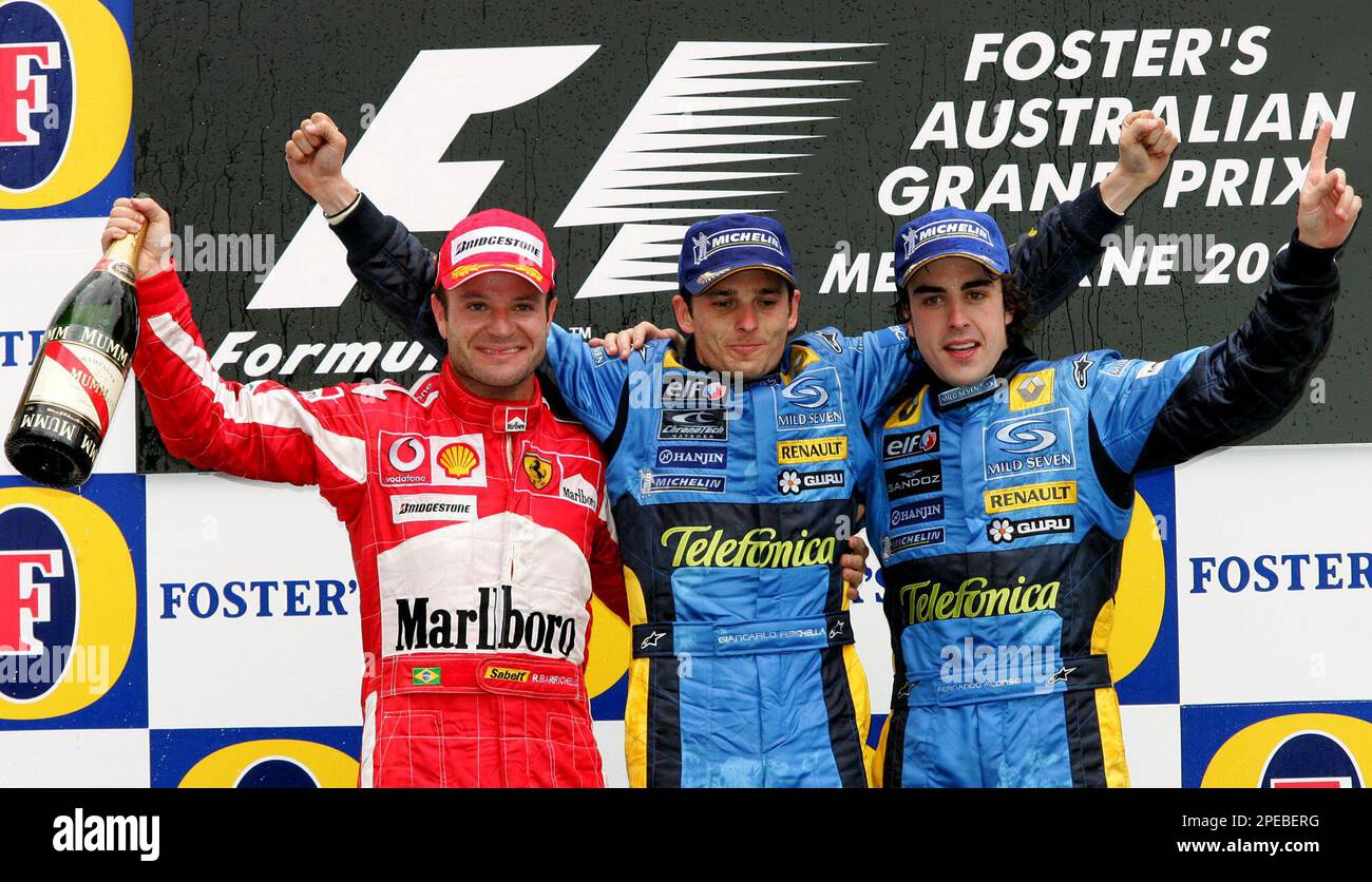 Italy's Giancarlo Fisichella, center, stands with Renault teammate Fernando Alonso of Spain ...
