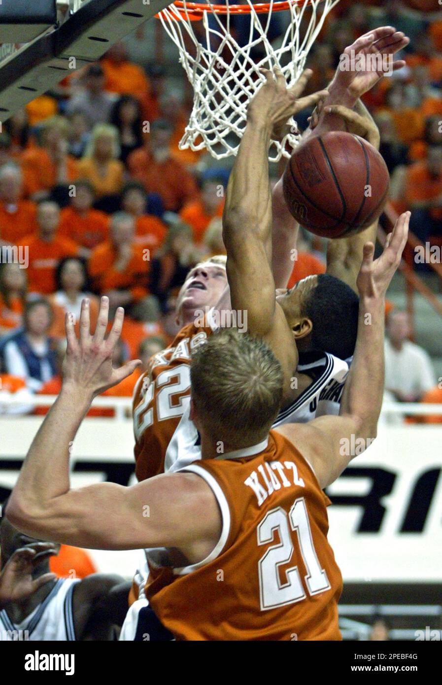 Texas forward Brad Buckman, left, and center Jason Klotz, center, team ...