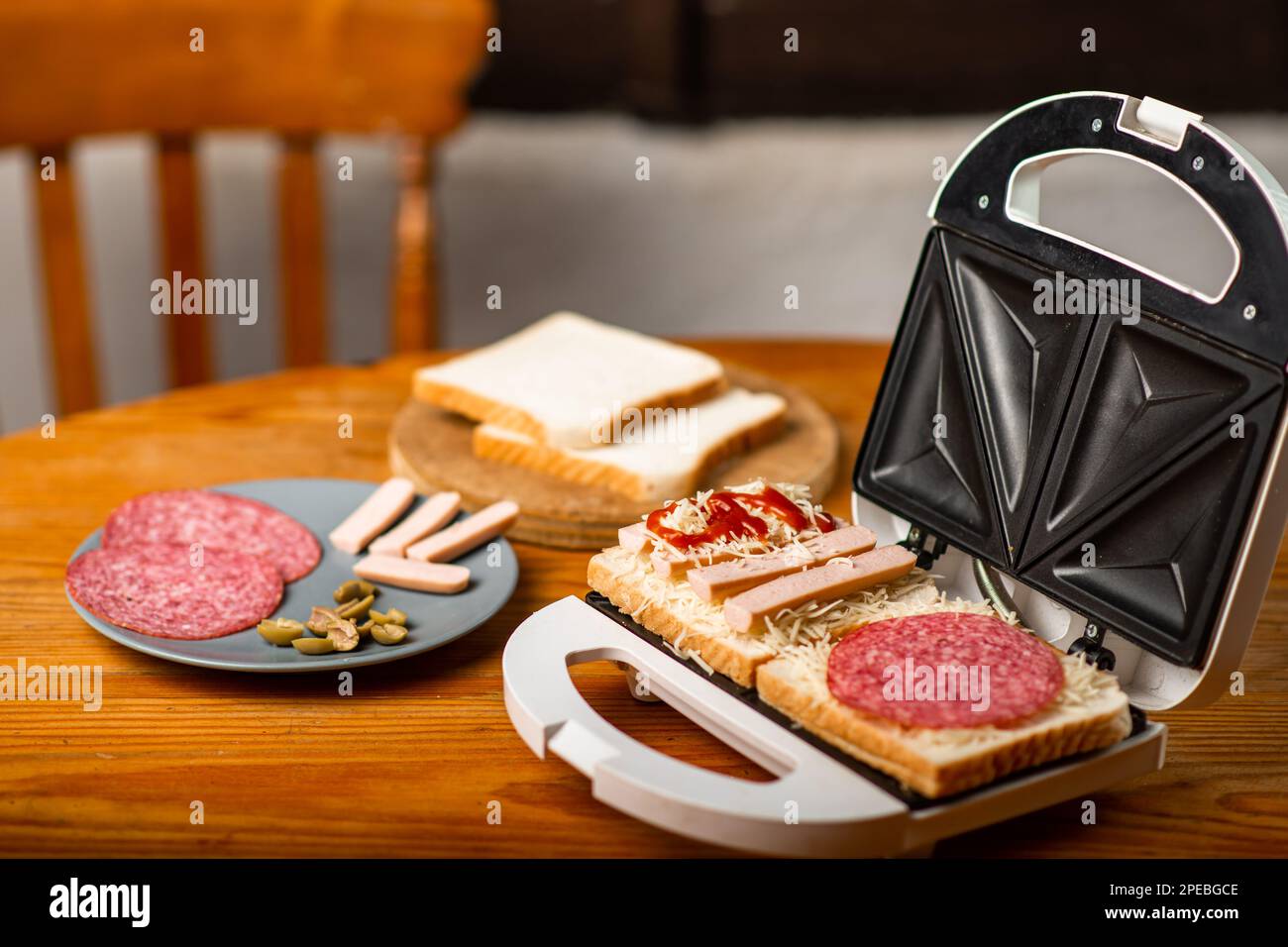 Sandwich maker and sandwich making. Different ingredients lie side by ...