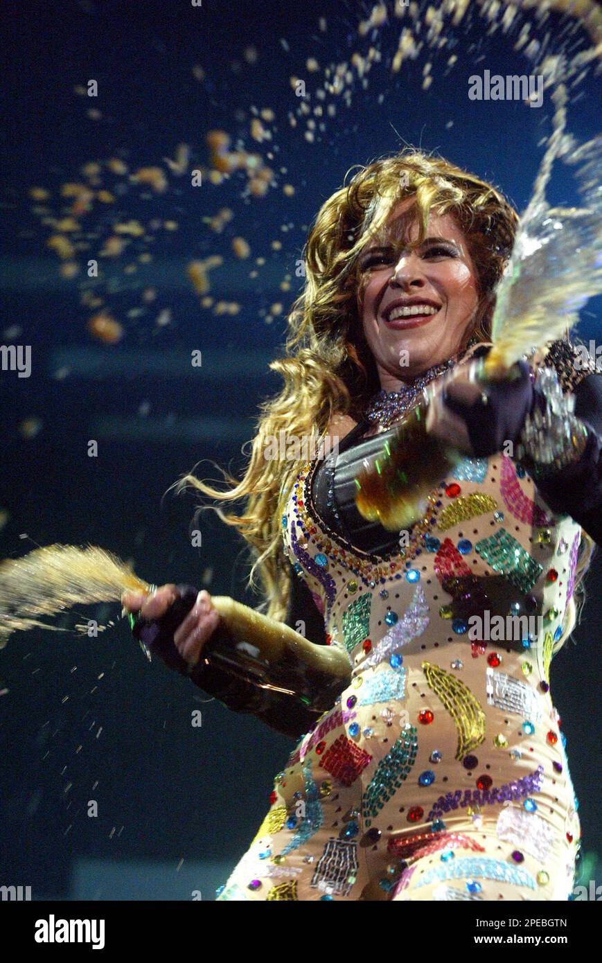 Mexican pop singer Gloria Trevi sprays liquid at the audience during ...