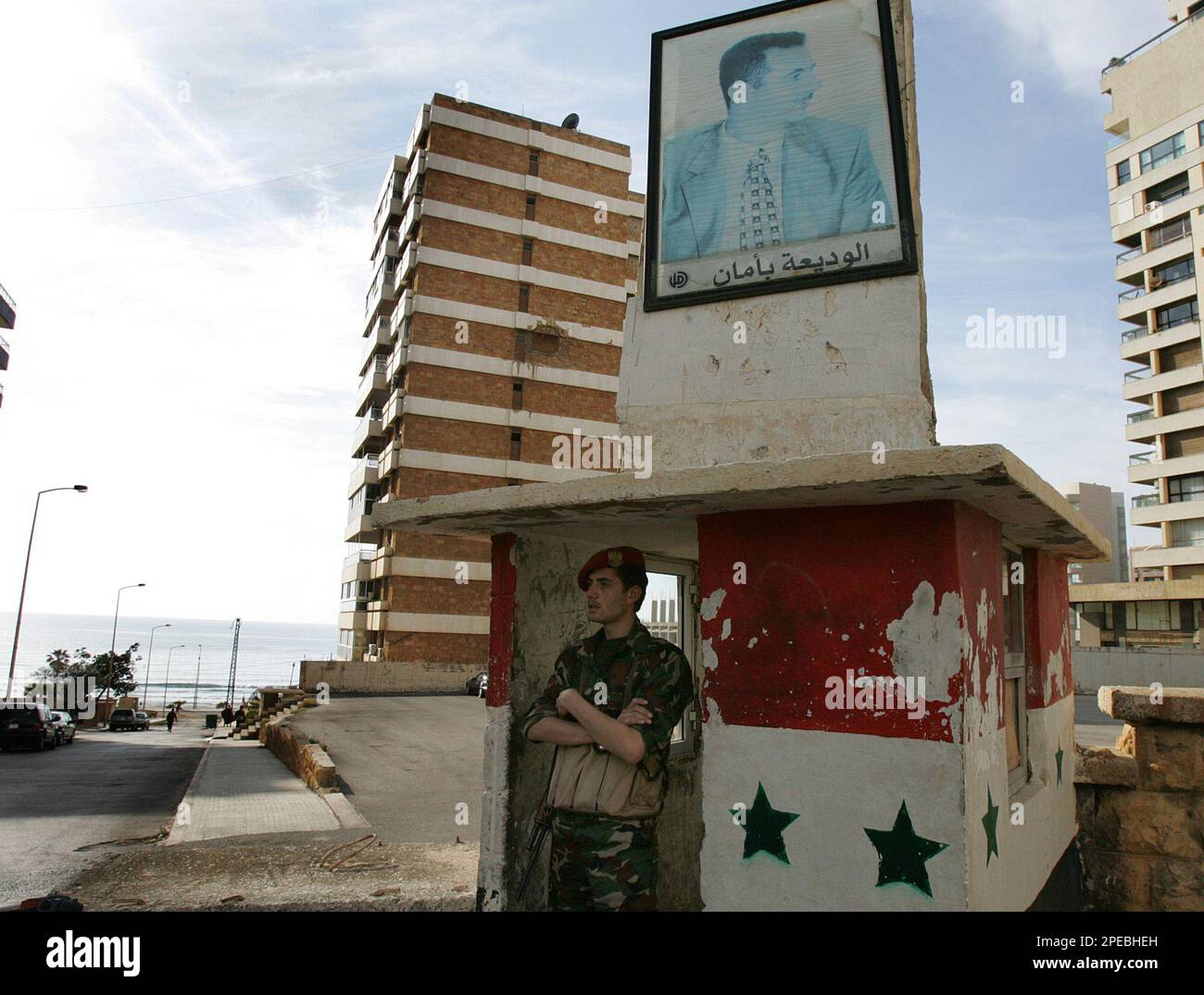 A Syrian soldier stand guards at the checkpoint of Syrian intelligence ...