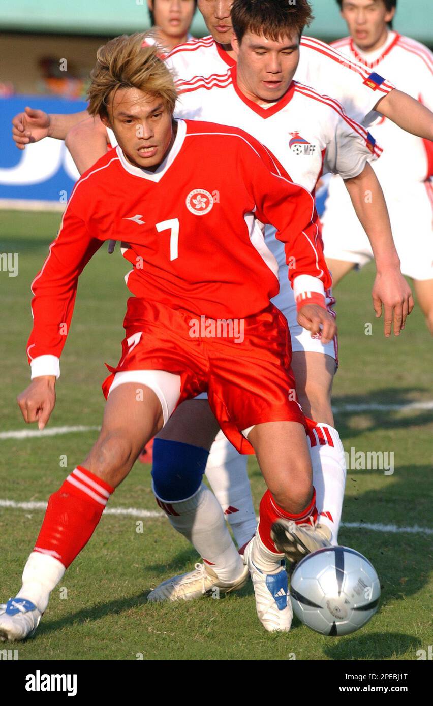 Hong Kong's Au Wai-lun dribbles pass Mongolian defenders during the East Asian Football ...