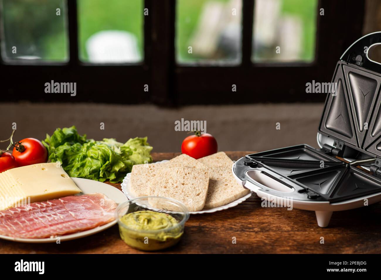 Cooking sandwiches in a sandwich maker. Different ingredients - bread ...