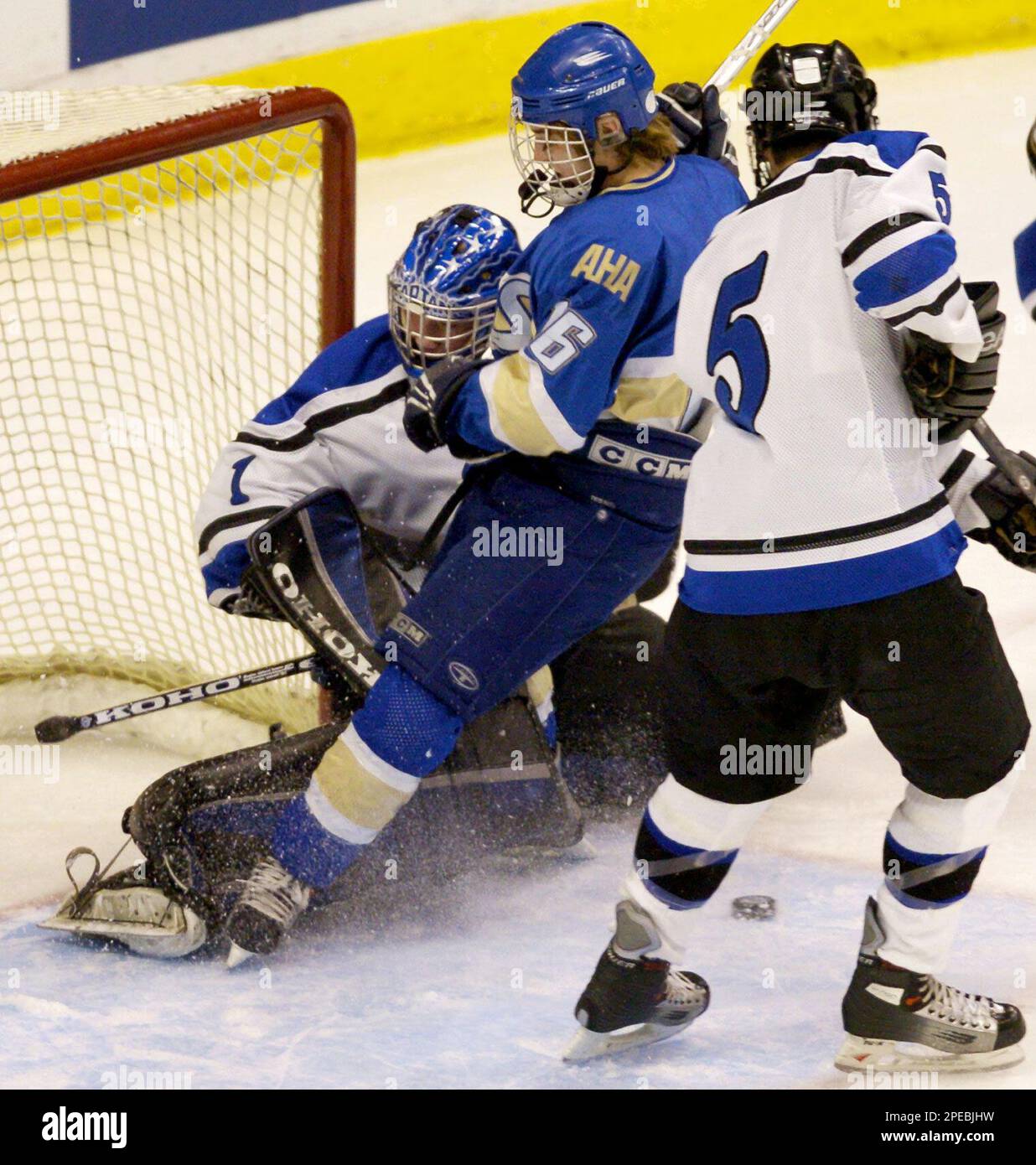 Tartan goalie Cary Wood, left, stops the puck and Holy Angels' Jay ...